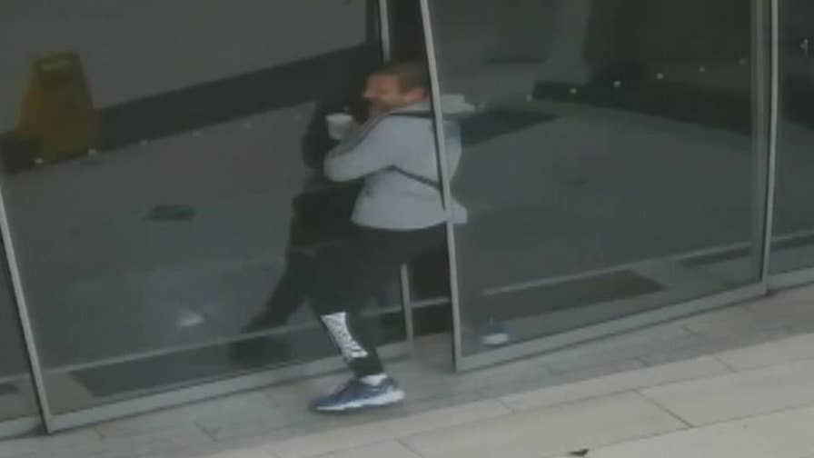 Security Footage Shows Robber Getting Stuck In Pair Of Sliding Doors