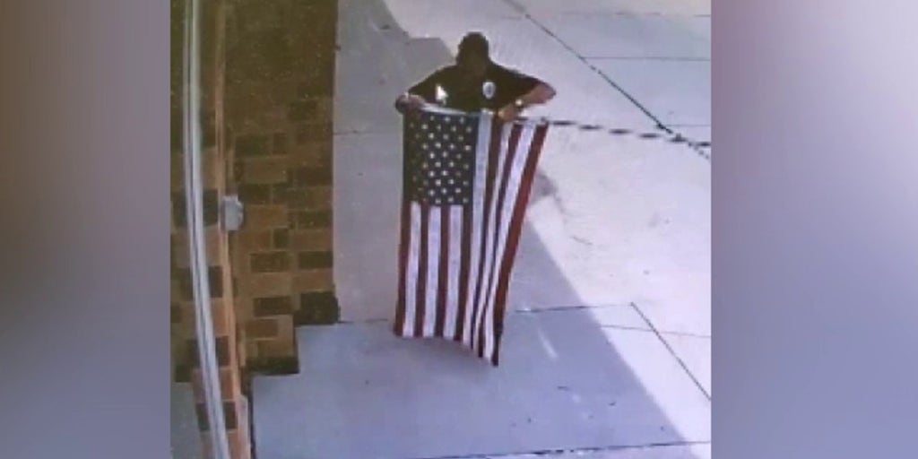 Raw Video: Police officer stops to fix fallen flag outside Nebraska ...