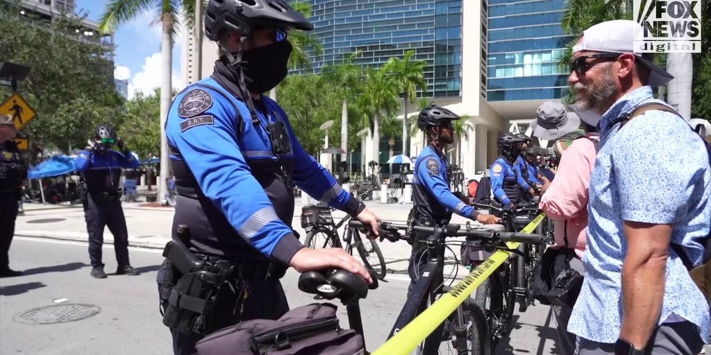 Police move media behind yellow tape outside court | Fox News Video