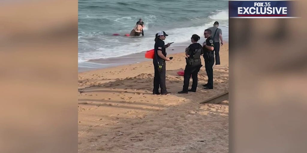 Florida police officer credited with helping rescue two struggling ...