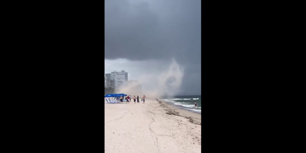 Stunning video reveals how beach storm grabbed vacationer's umbrella ...