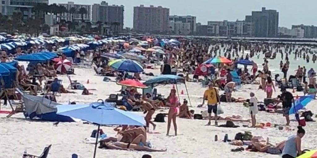 Spring breakers crowd Florida beach despite calls for social distancing ...