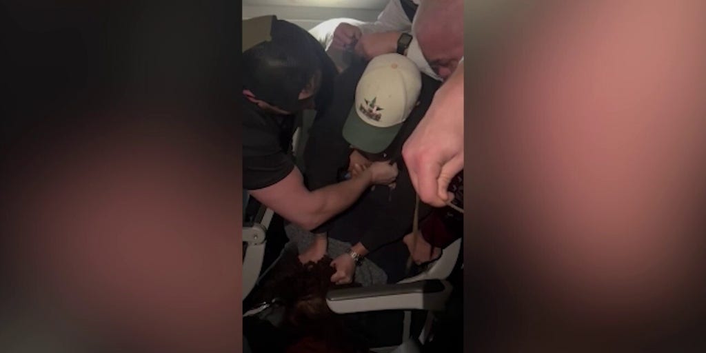 Frontier passenger tackled after allegedly banging window mid-flight | Fox News Video