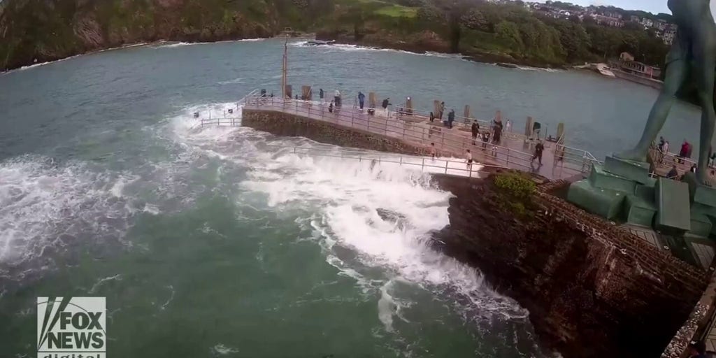 SEE IT: Child is swept off pier during high tide in petrifying moment ...