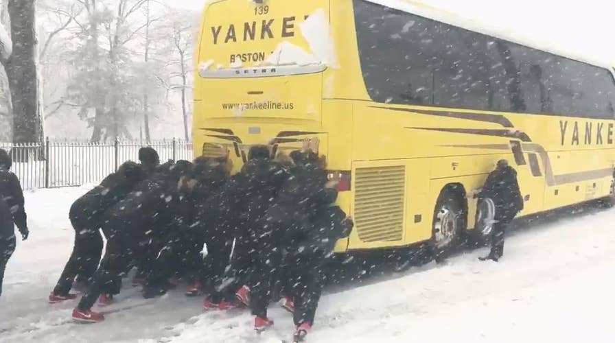 Northeastern women's basketball team pushes snow-trapped bus during nor ...