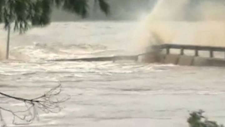Raging Texas floodwaters cause bridge to crumble, spur evacuations