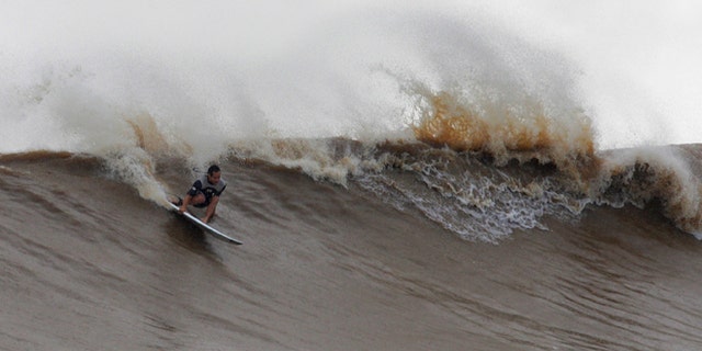 Miles-long wave making its way to the Amazon, surfers happily line up ...