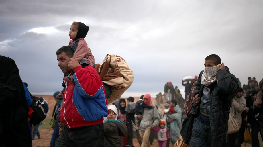Syrian Refugees Flee To Safety In Jordan Walking Through The Remote