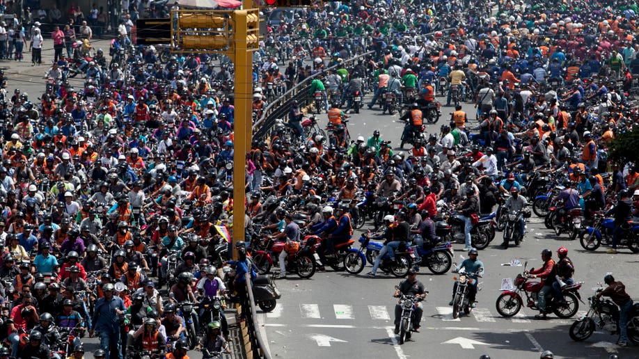 Motorcycles swarm streets of Venezuela's capital to protest proposed ...
