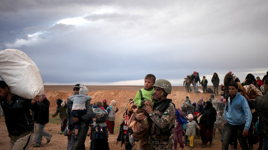 Syrian Refugees Flee To Safety In Jordan Walking Through The Remote