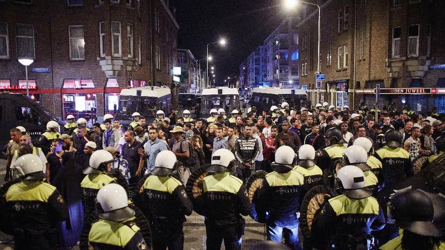 Riots after death of man in police custody draw comparisons with US ...