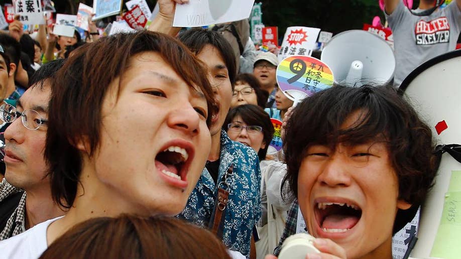 Tens Of Thousands Rally Outside Japanese Parliament To Protest Divisive