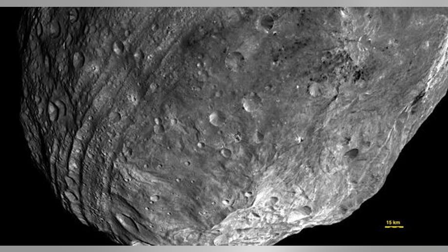 Dark Asteroids Streak Vesta's Surface With Carbon, NASA Probe Finds ...