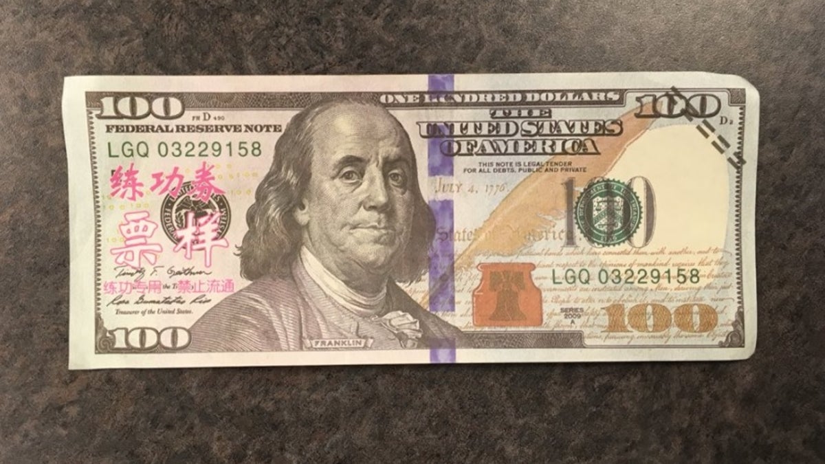 Woman Tried To Pass Off Fake 100 Bills With Pink Chinese Lettering woman-tried-to-pass-off-fake-100-bills-with-pink-chinese-lettering