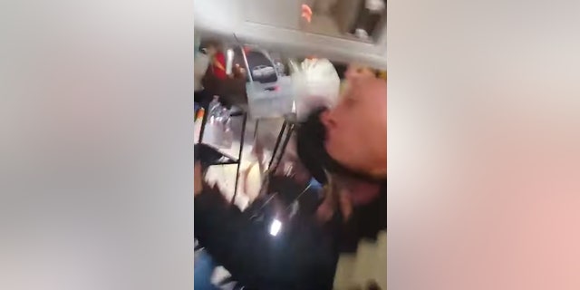 Video Shows Flight Attendant Hitting Plane Ceiling Passenger Praying