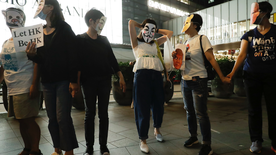 Hong Kong Protesters Don Cartoon Masks To Defy Face Mask Ban