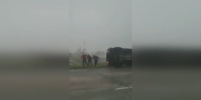 Houston UPS driver rescued after truck topples onto side during ...