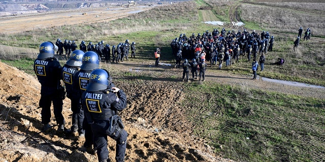 Greta Thunberg smiles as German police carry her away during ...