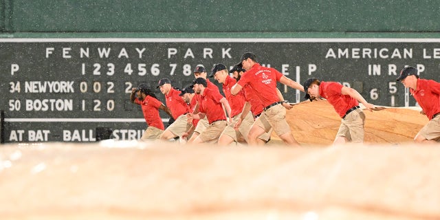 Red Sox fans take advantage of flooded Fenway Park during rain delay ...