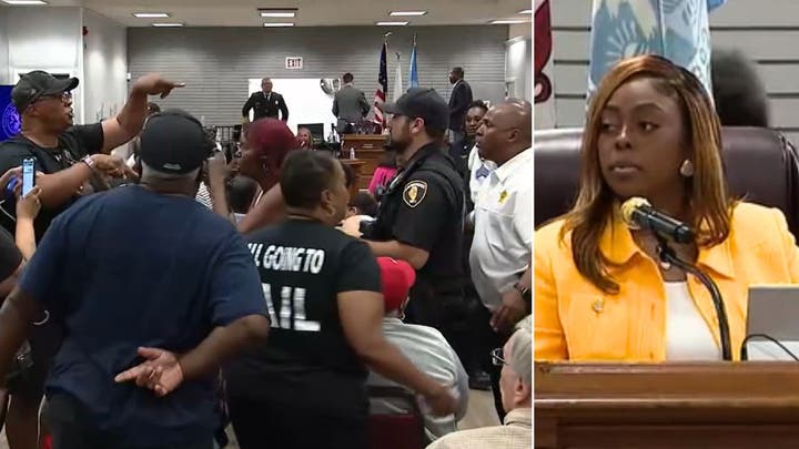 Controversial mayor sits with gold microphone as meeting over lavish ...